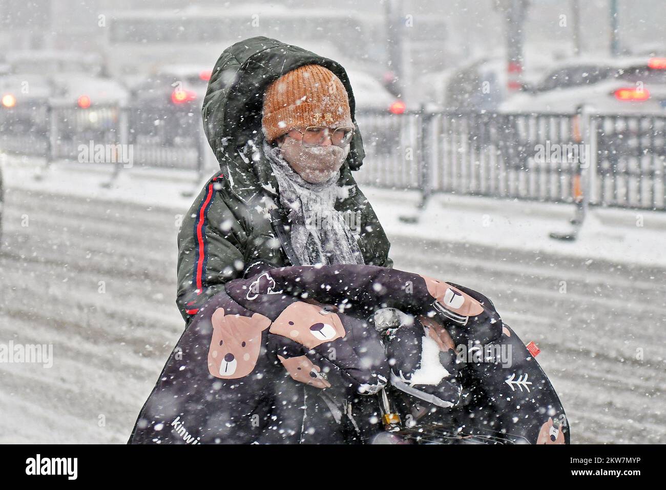 YANTAI, CHINA - NOVEMBER 17, 2022 - People brave snow on a street in ...