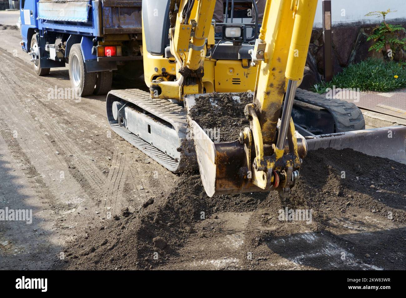 Repaving the road, The excavator is leveling gravel on the road, making ...