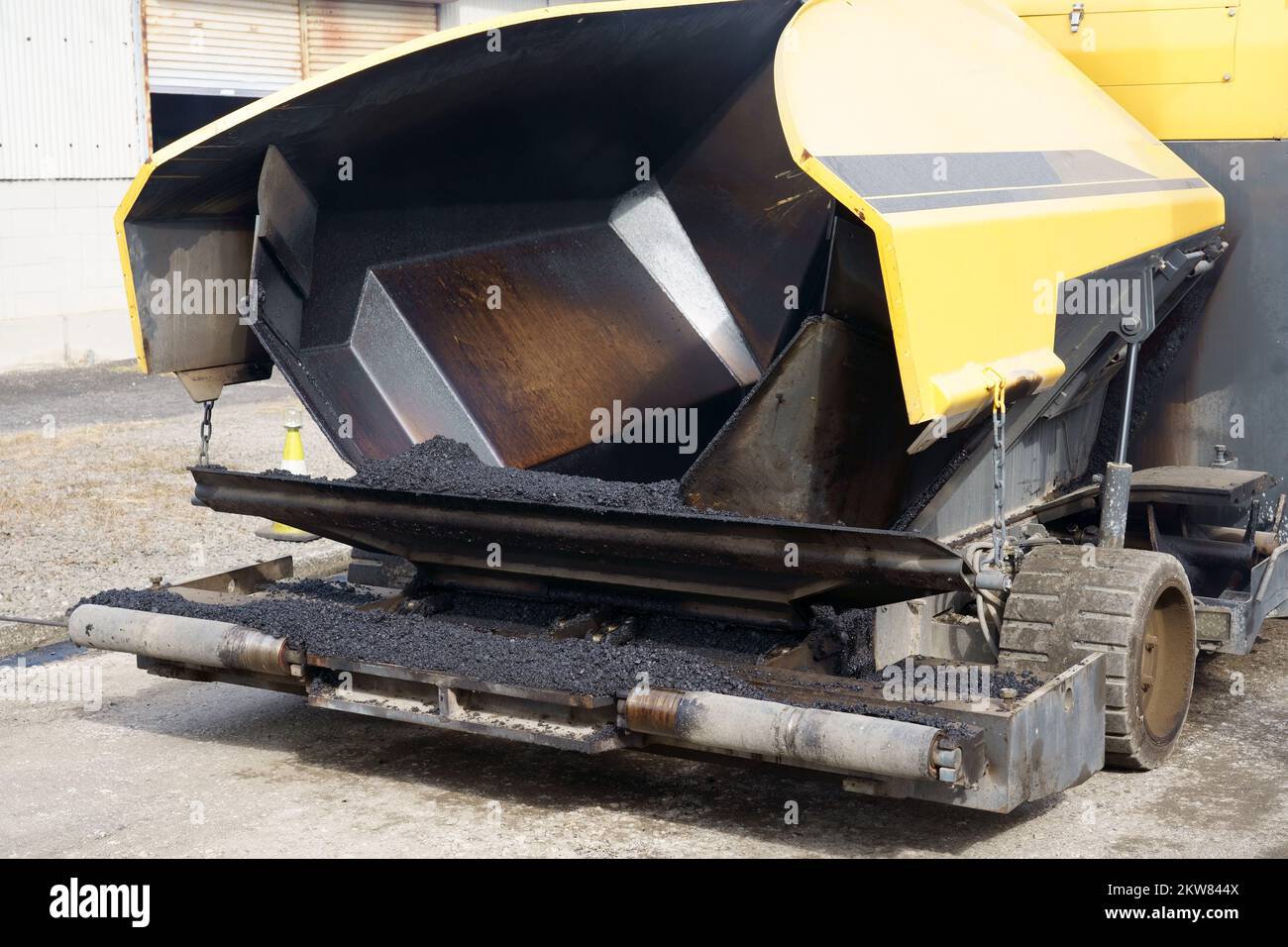 Paver finisher, asphalt finisher or paving machine placing a layer of ...