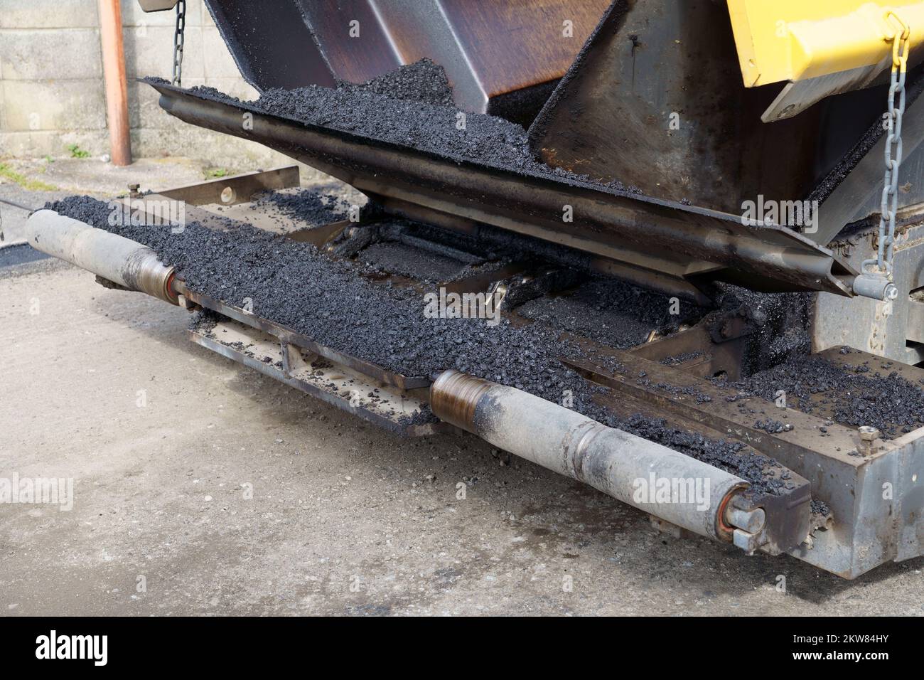 Paver finisher, asphalt finisher or paving machine placing a layer of ...