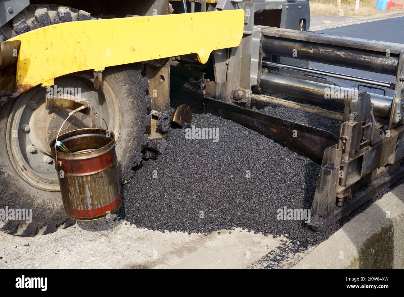 Paver finisher, asphalt finisher or paving machine placing a layer of ...