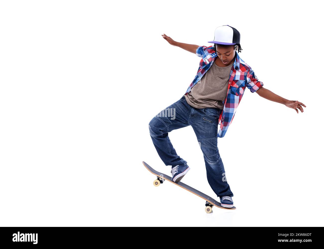 Born for boarding. An African-American boy doing a trick on his ...