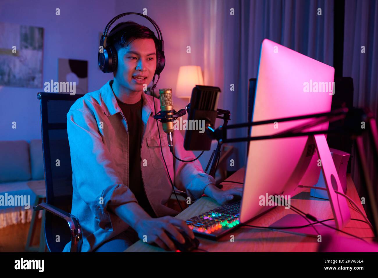 Positive lets player recording video for his channel at desk in his ...