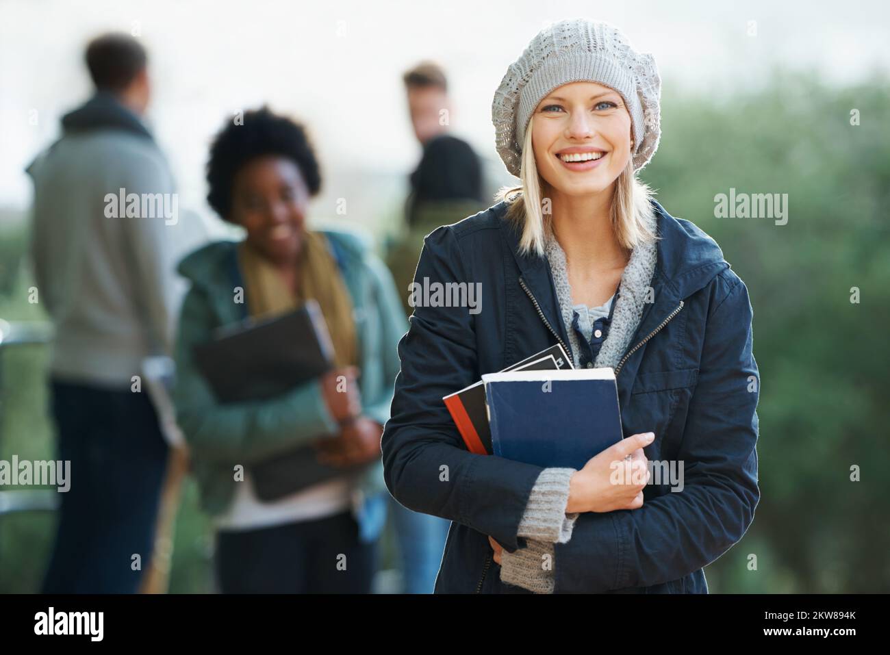 Study break with friends. Portrait of a young student standing outside ...