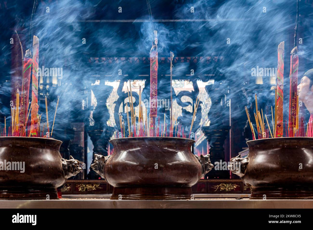 Burning incense sticks at Hoi Quan Tue Thanh temple, Ho Chi Minh City ...