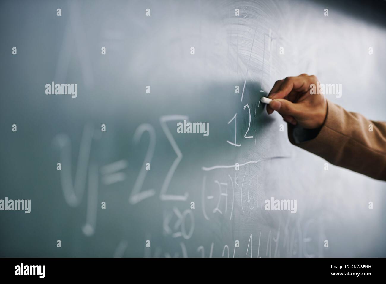 Its all in the formula...Cropped image of a teacher writing a formula ...