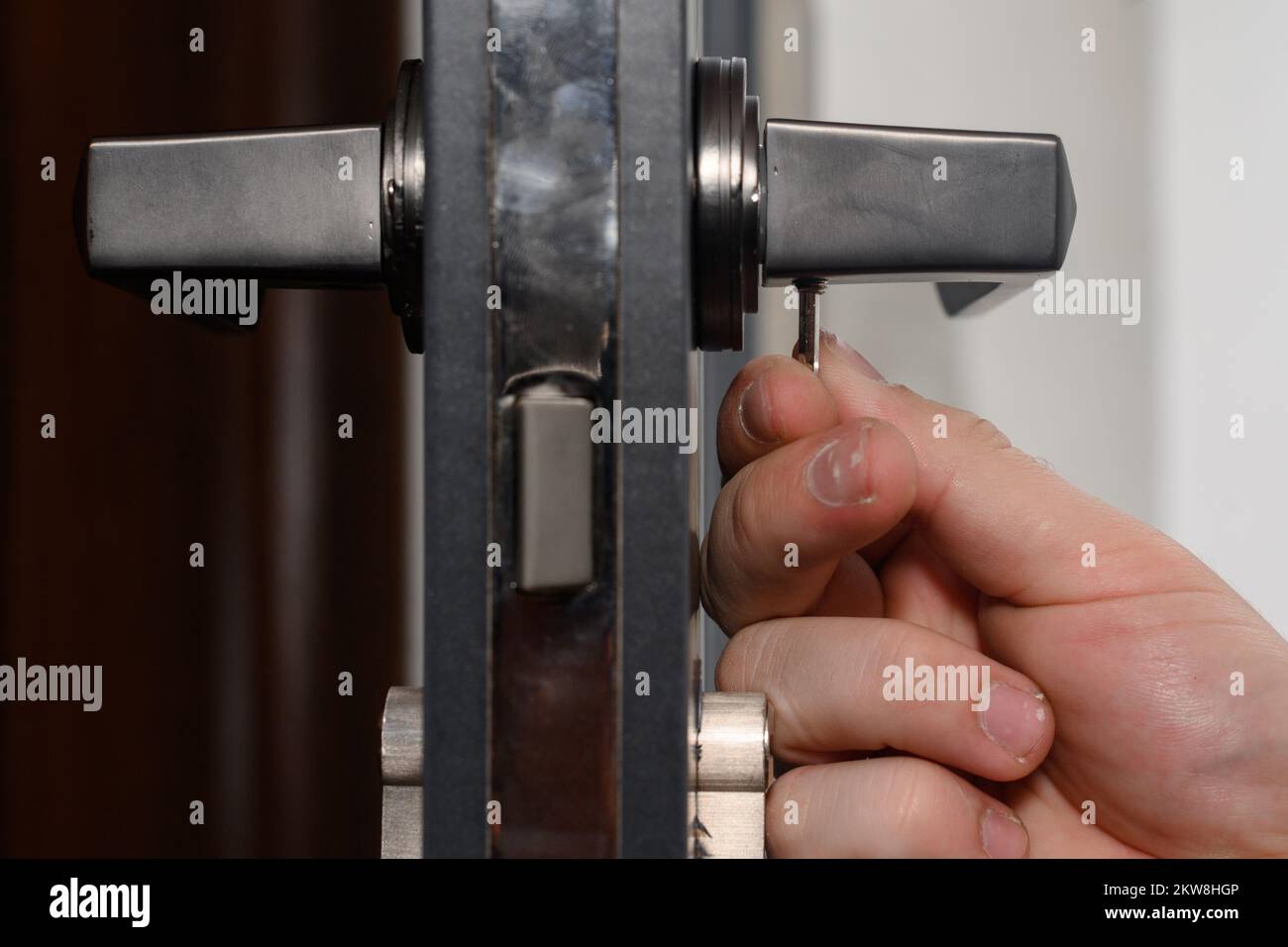 Hex key and installation of door lock and handle, close-up installation ...