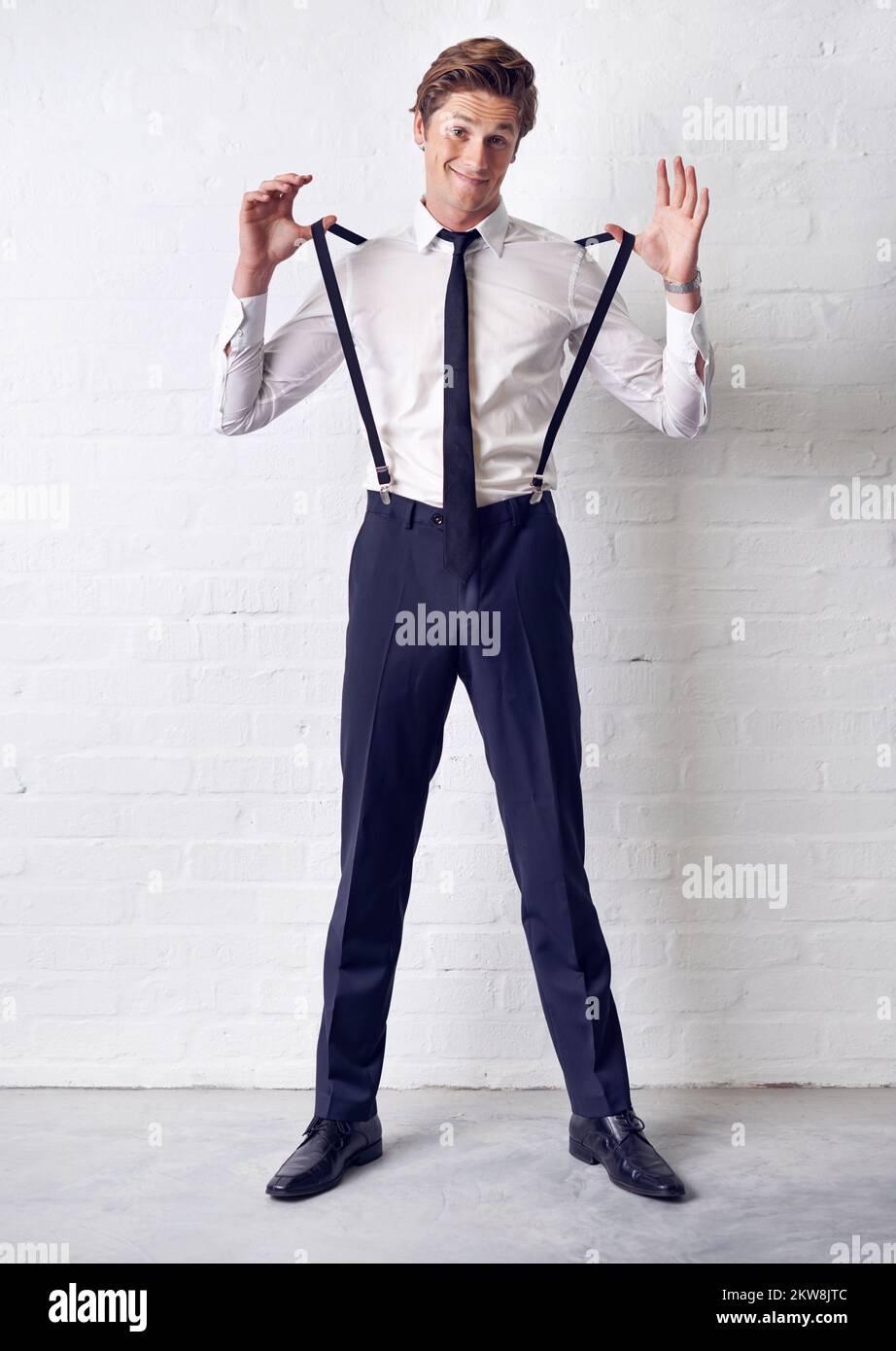 Adding a touch of style. Full length shot of a well dressed young man ...