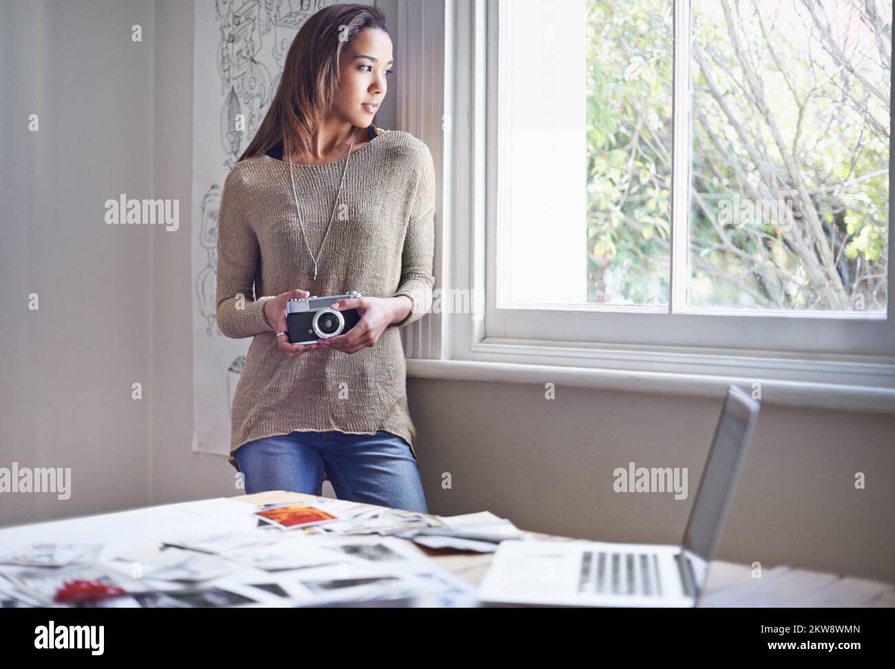 Contemplating her next photographic study. A young photographer ...