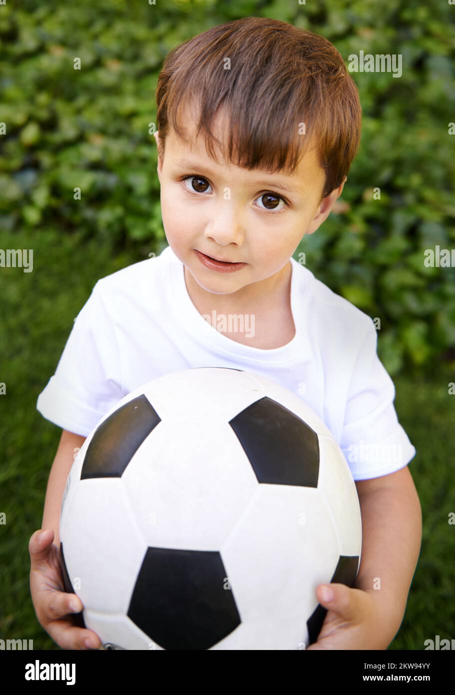 Wanna see my cool soccer skills. an adorable little boy playing with a ...