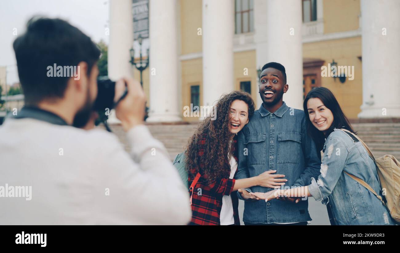 Multiethnic group of foreign tourists is taking photos posing for ...