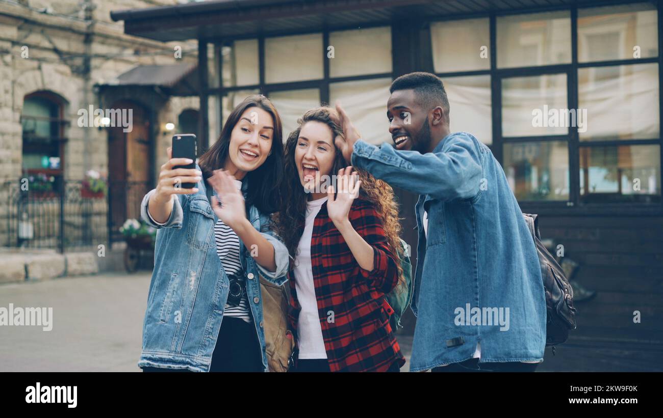 Excited young people foreigners are making online video call using ...
