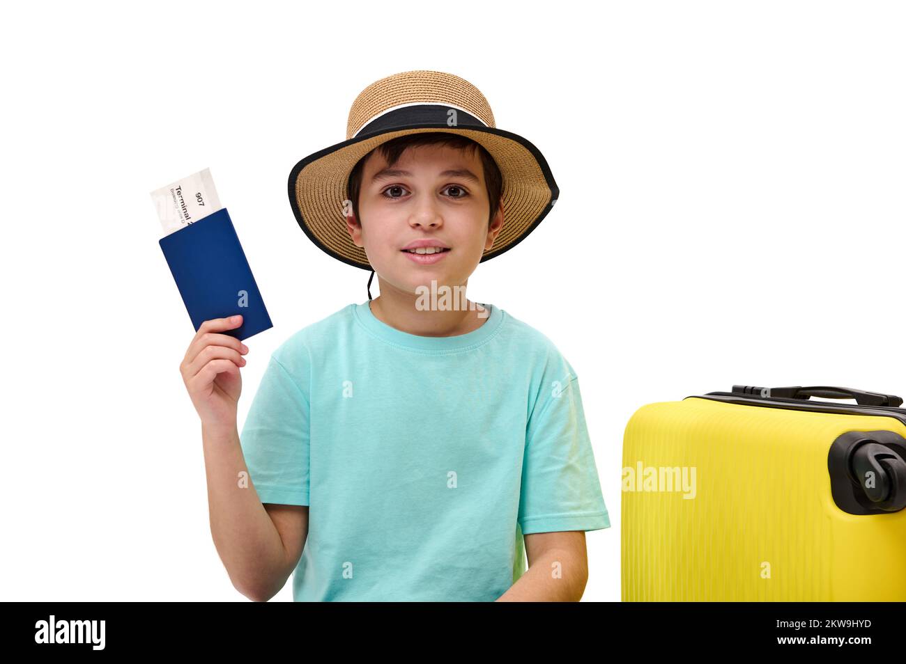 Adorable preteen traveler boy in blue t-shirt and straw hat, going for ...