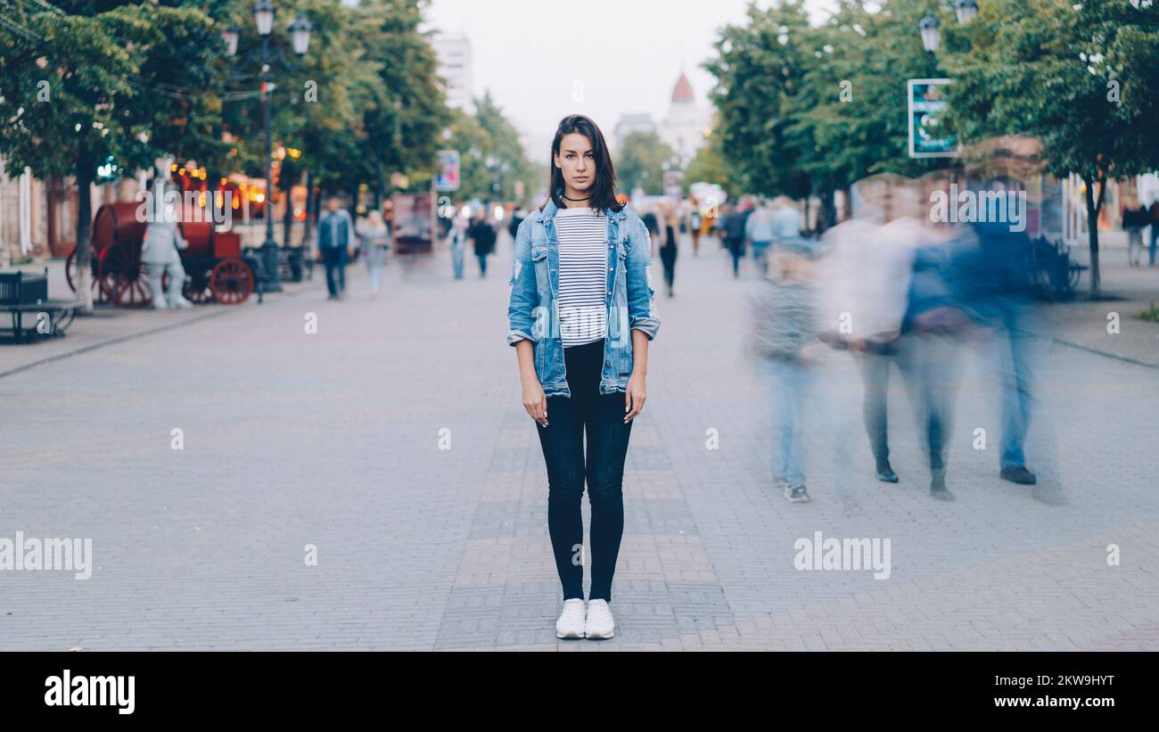 Portrait of pretty girl in trendy clothing looking at camera standing ...