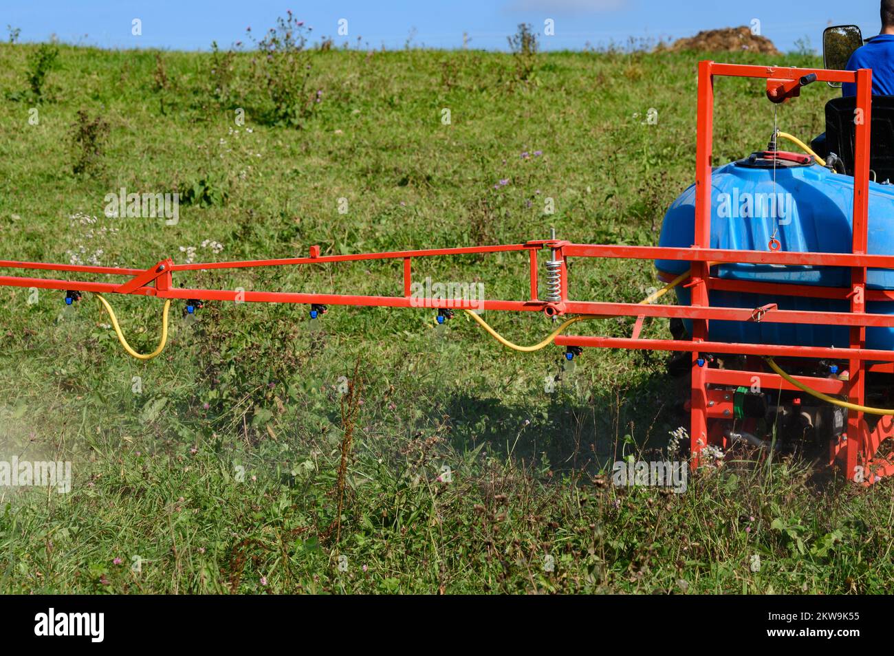 A tractor with a tank and attached equipment for spraying the field ...