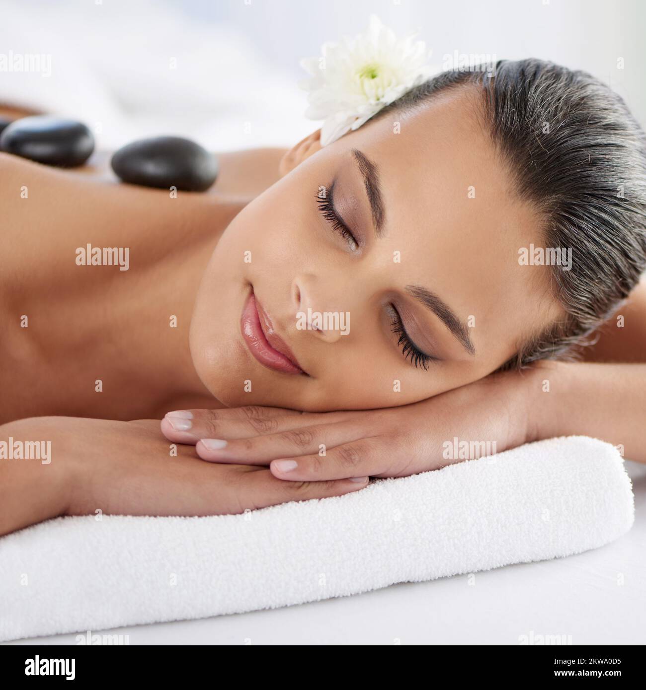 This feels amazing. a beautiful young woman relaxing during spa ...