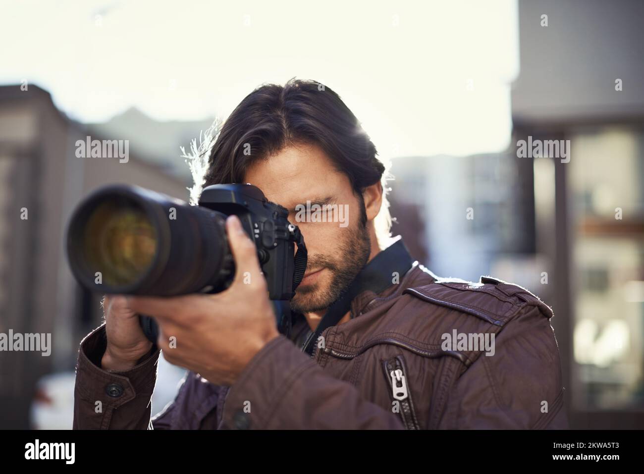 Photography is my passion. a handsome young photographer at work in the ...