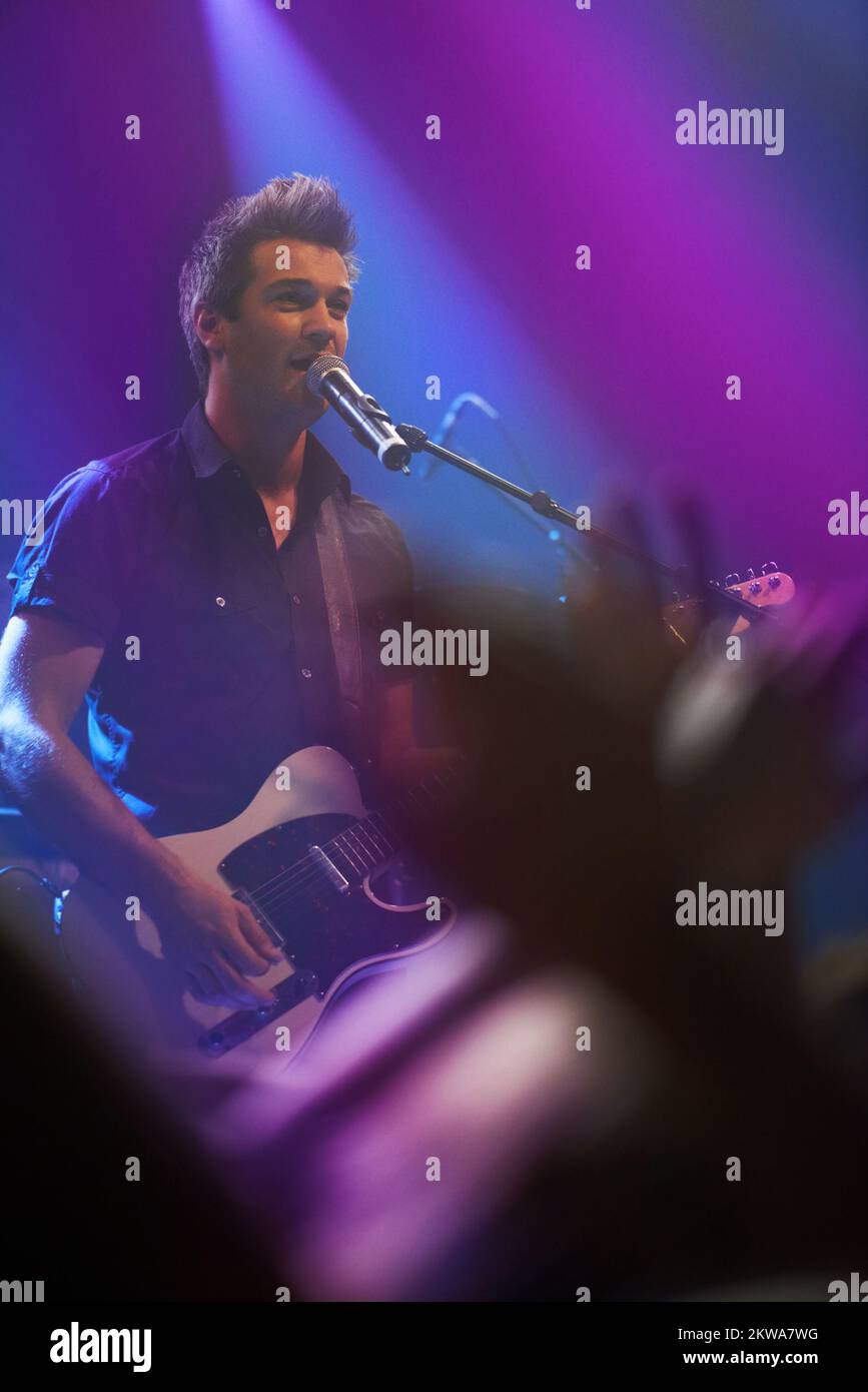 Moving the crowd with the sound of his voice. a performer singing a ...