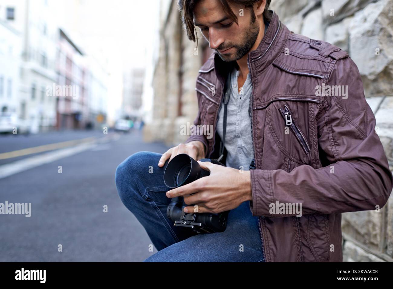 Photography is my passion. a handsome young photographer at work in the ...