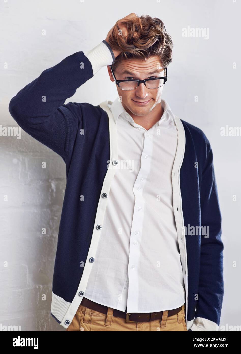 Im confused bro...A perplexed young man standing with his hand in his ...