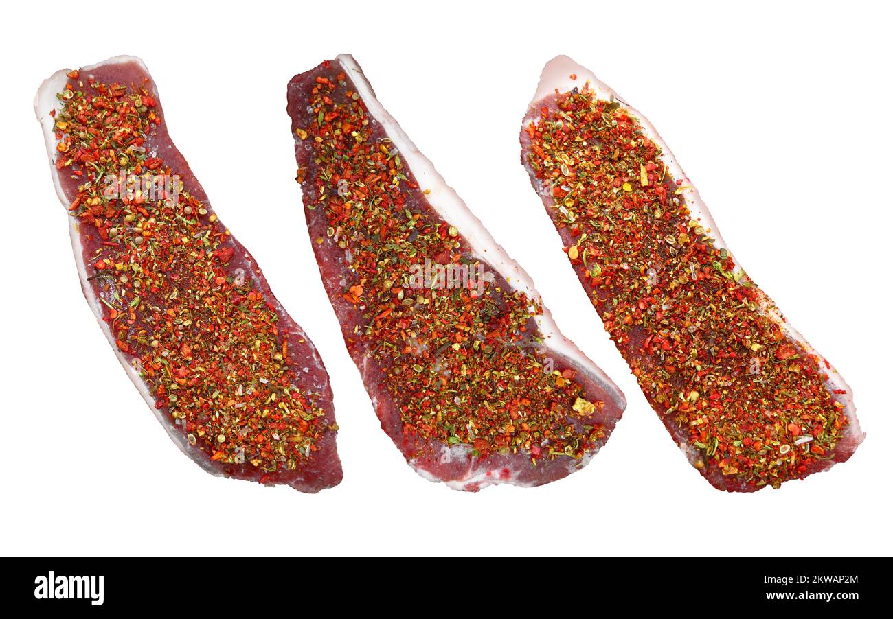 Three raw beef steaks with spices for grilling. Isolated on white Stock ...
