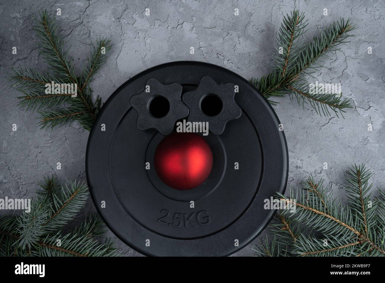 Gym dumbbells weight plate shaped as a reindeer. Christmas tree ...
