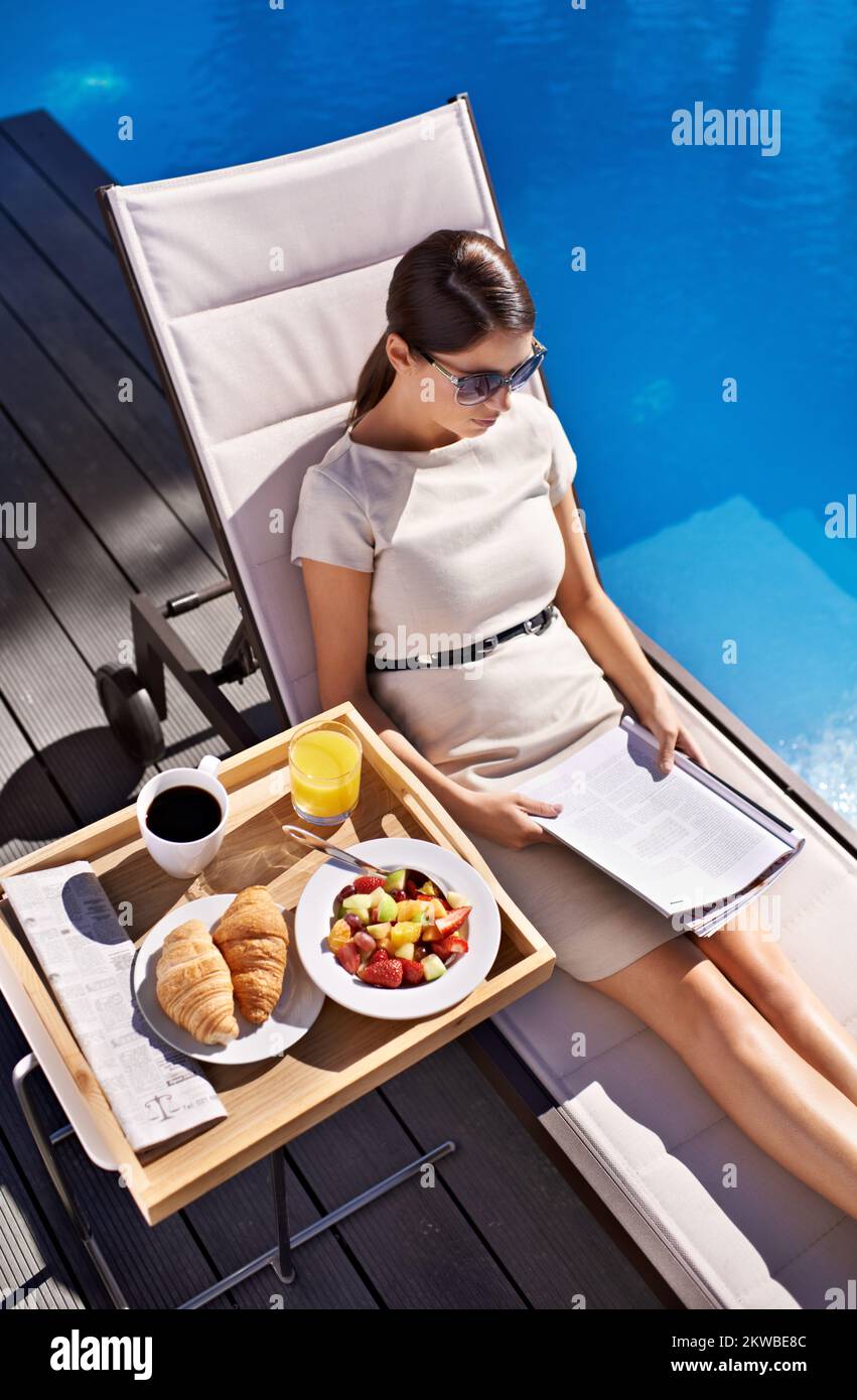 Holiday morning routine- a read before breakfast. An attractive young ...