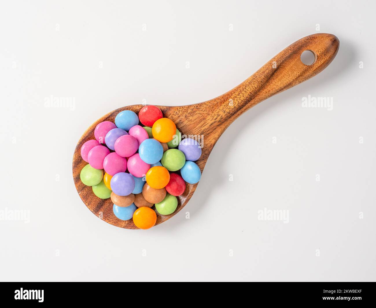 teak wooden rice serving spoon with multi colored sugar candy coated ...