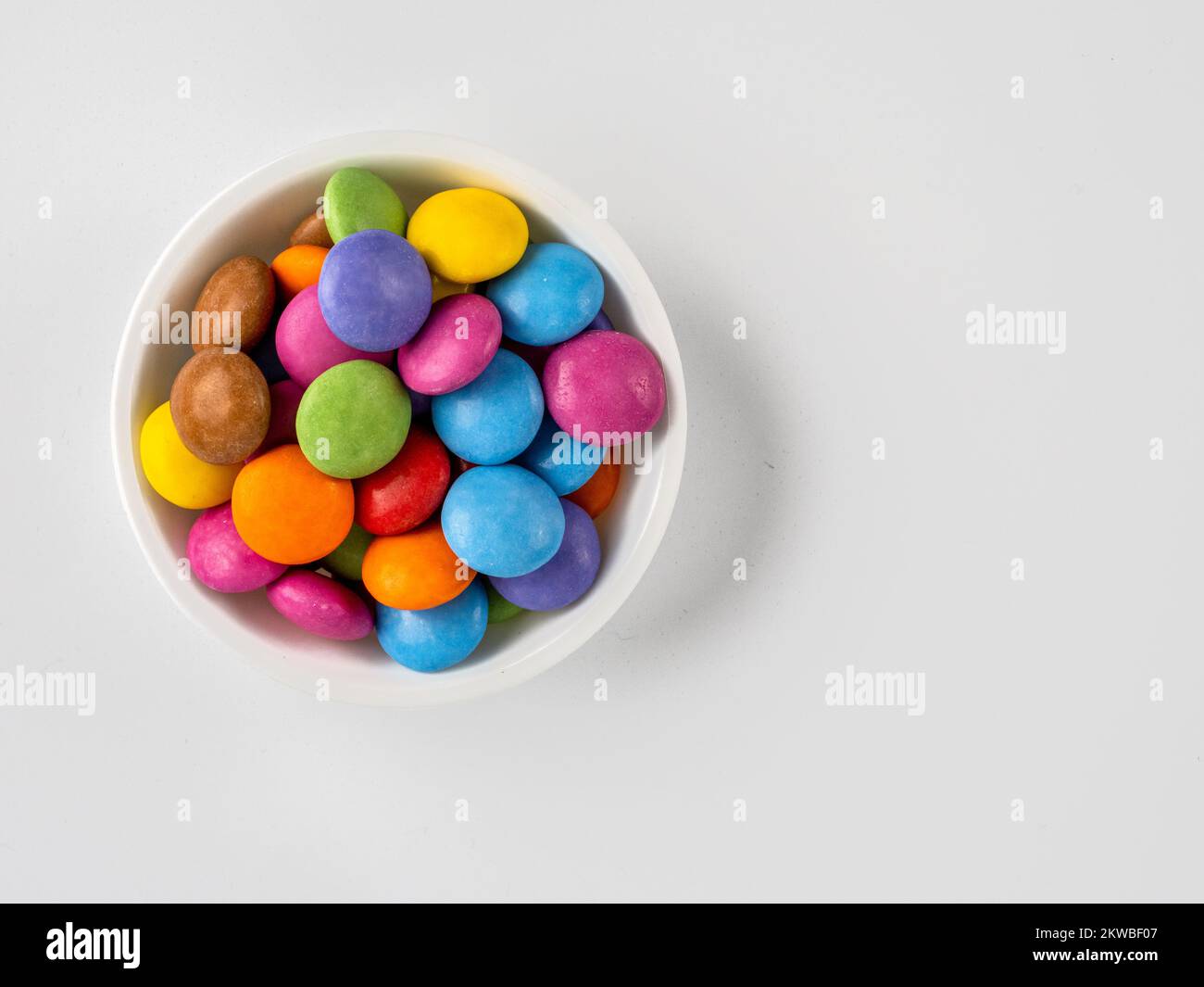 ramakin of candy on a white background Stock Photo - Alamy