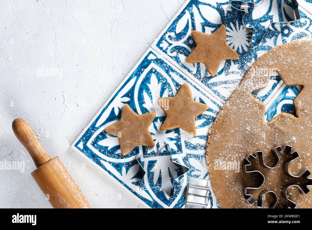 Making homemade Christmas cookies, rolled out dough, cutting cookies ...