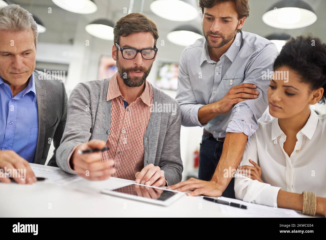 Hard working office pros. a group of young professionals working at a ...