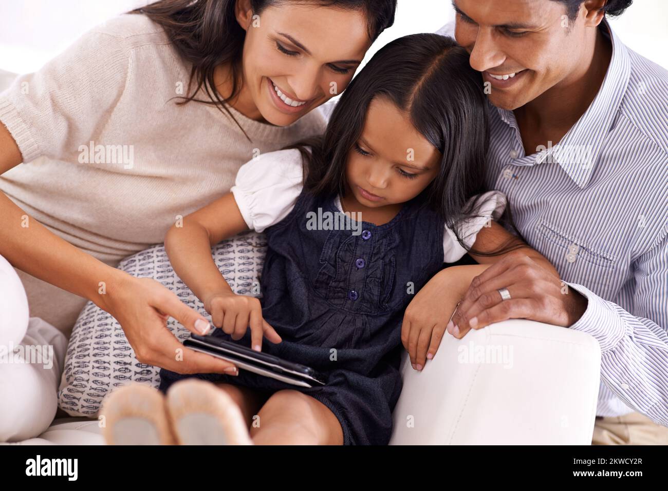 Showing them how its done. an affectionate young family sharing a ...