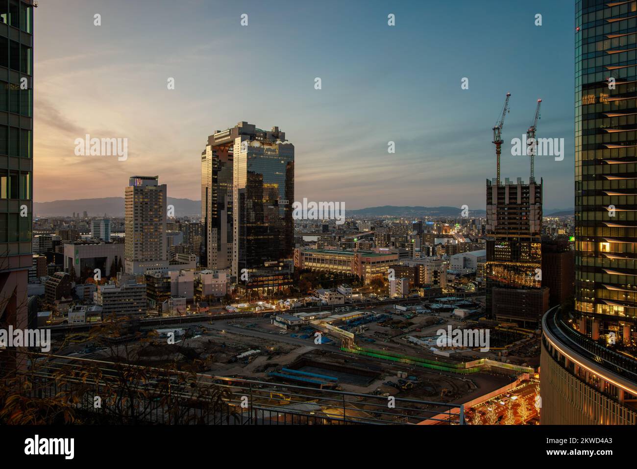 Beautiful sunset sky as lights come on in central Osaka towers Stock ...