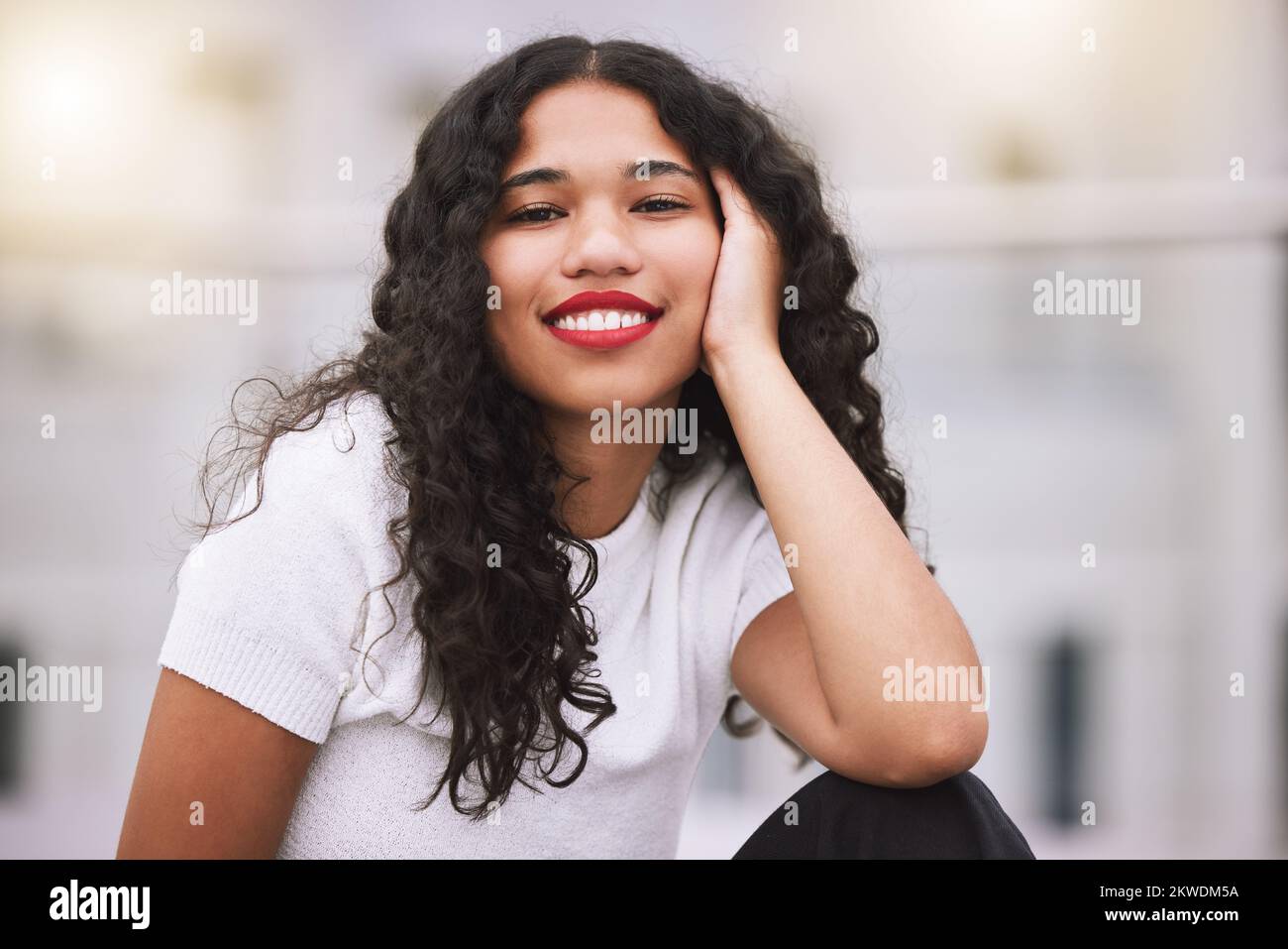 Trendy, young and urban curly hair Mexican girl with attractive ...