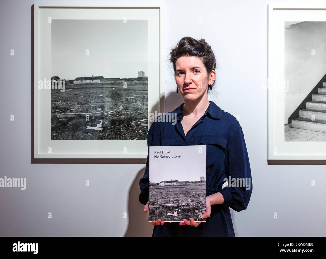 Curator Helen Scott with catalogue and photographs at Paul Duke ...