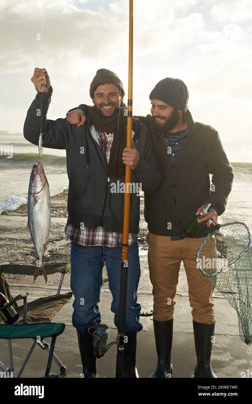 Damn....I wish Id caught that one.two young men fishing off a pier ...