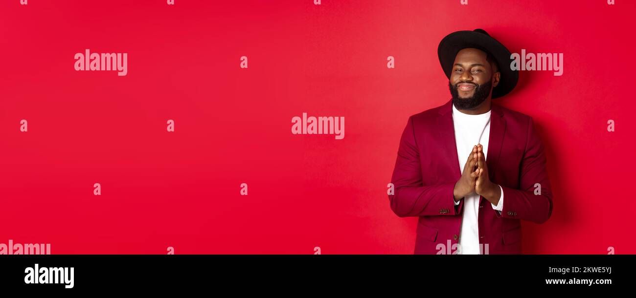 Handsome successful Black man relish profit, rub hands and smiling ...