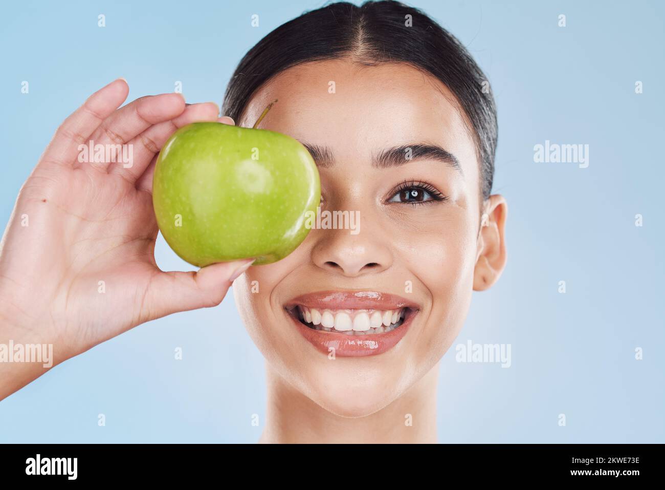 Apple, beauty and skin of a woman with a smile holding a fruit on her ...