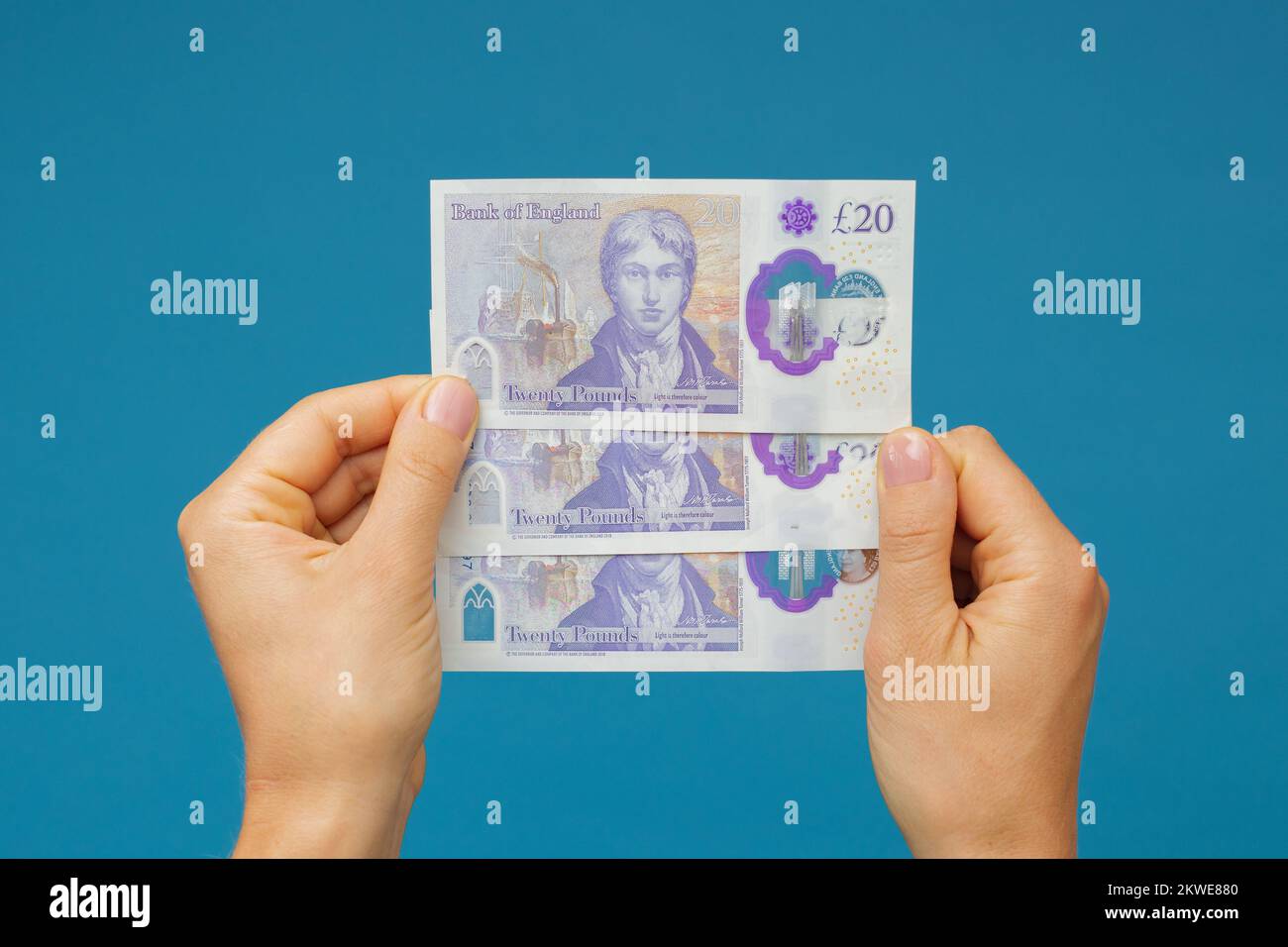 Image woman's hands which holds British pounds in her hands isolated ...