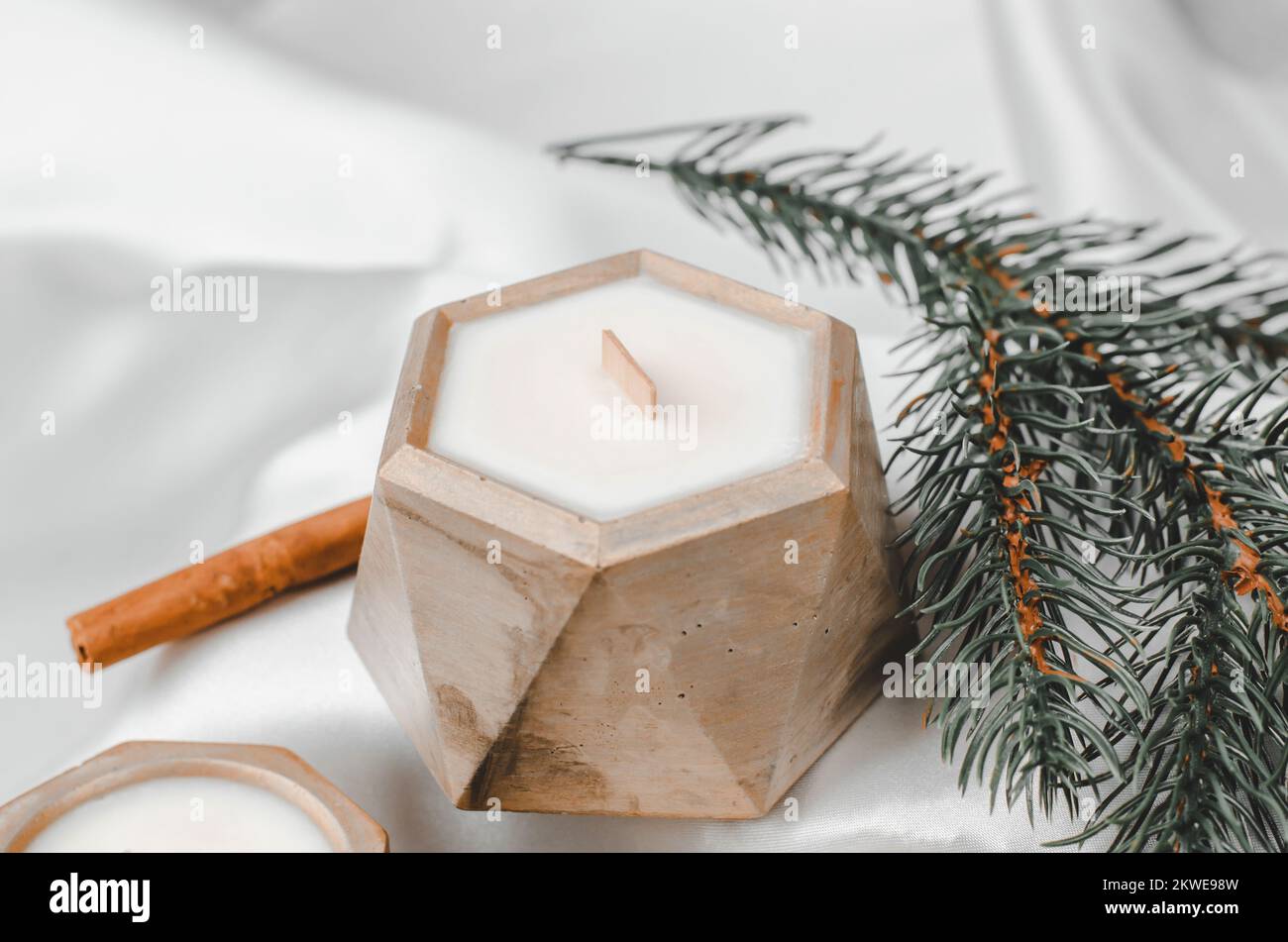 Candle with wooden wick and fir branches, festive composition ...