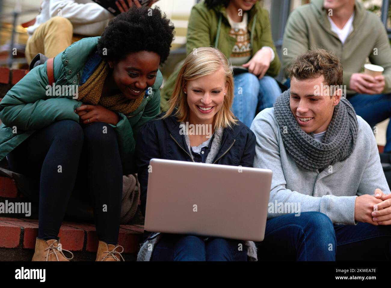 All your study material in one place. a group students looking at a ...