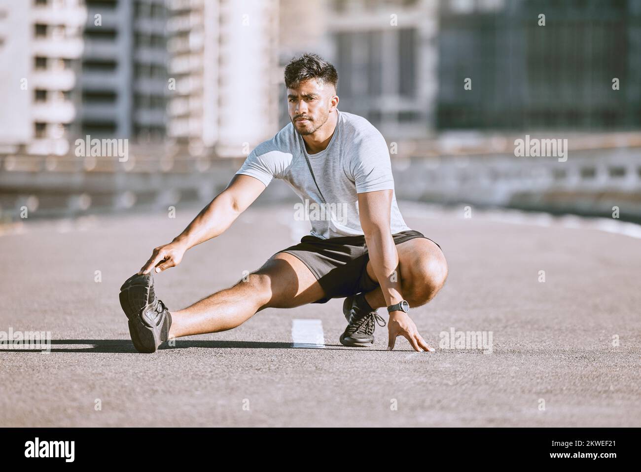 Fitness muscles stretching in city street, young man daily jogging and ...