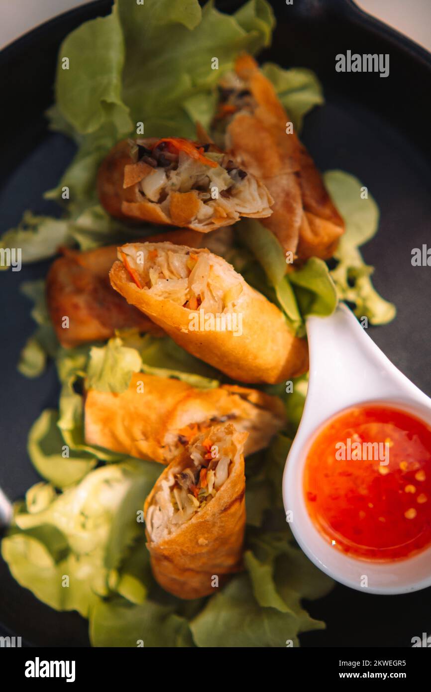 Beautiful thai food on a plate. Spring rolls with spicy sause, chicken ...