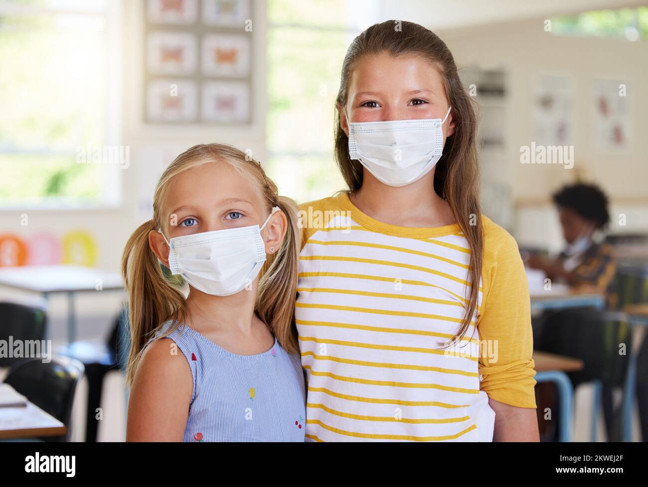 Young kids learning in classroom, after covid pandemic, wearing face ...