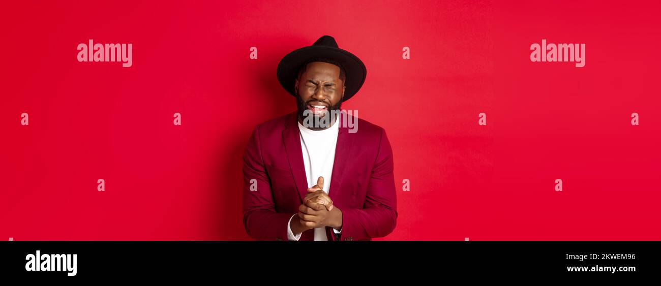 Miserable and heartbroken Black man crying, begging for help, holding ...