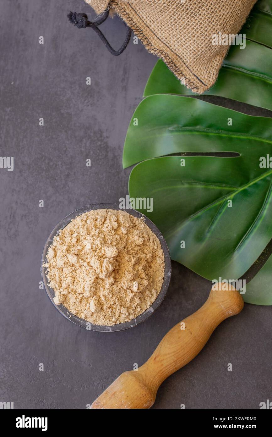 Top view of Gofio, Canarian flour, wood mortar and pestle, sacksful and ...