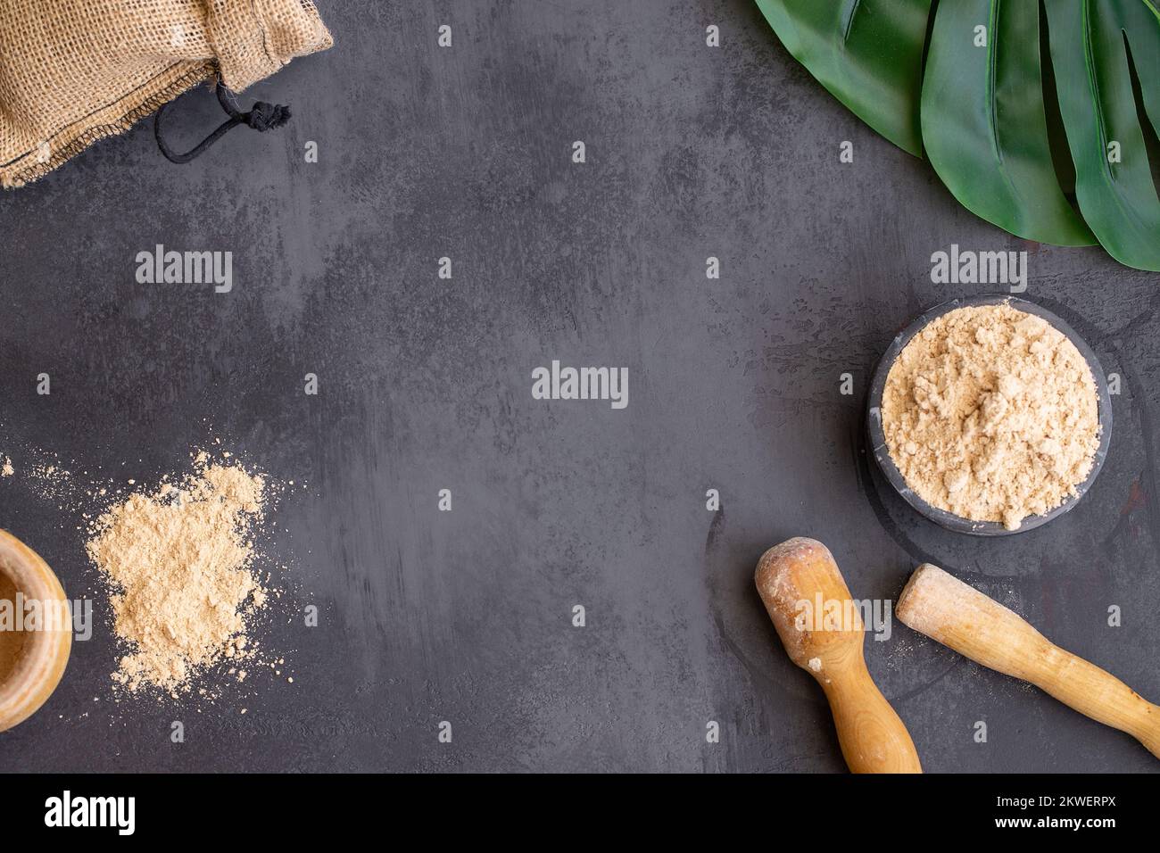 Top view of Gofio, Canarian flour, wood mortar and pestle, sacksful and ...