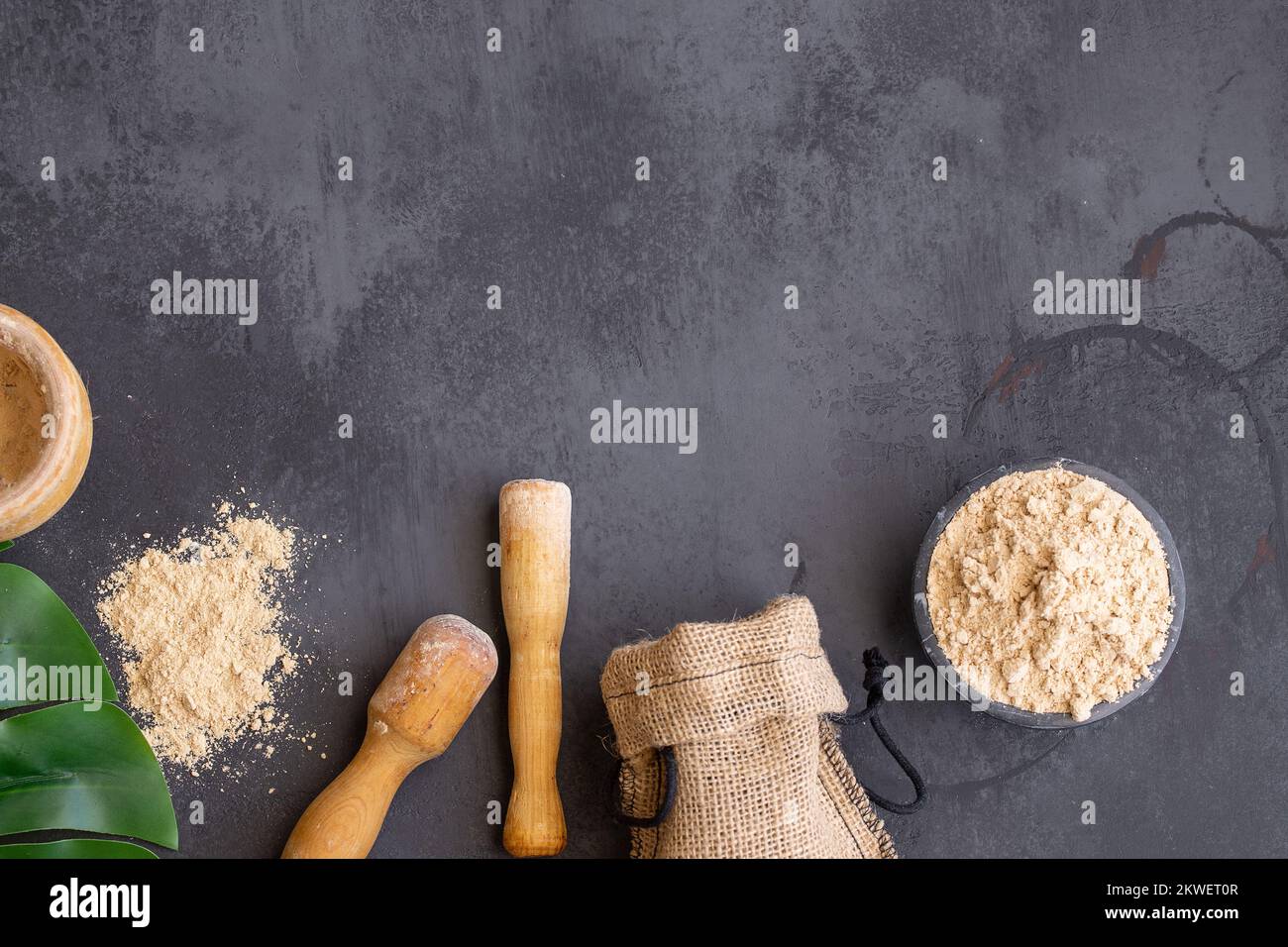 Top view of Gofio, Canarian flour, wood mortar and pestle, sacksful and ...