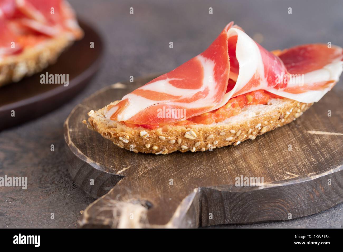 Close up of famous Spanish tapa toasted bread with tomato and Jamon ...