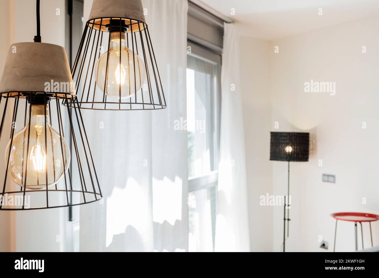 Detail of decorative lamps with large bulbs hanging from the ceiling of ...